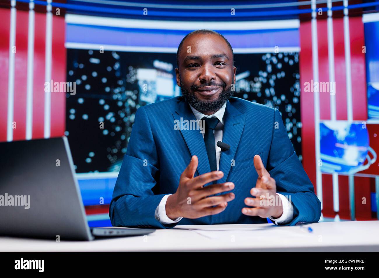 Night show host reading headlines in newsroom, presenting live ...