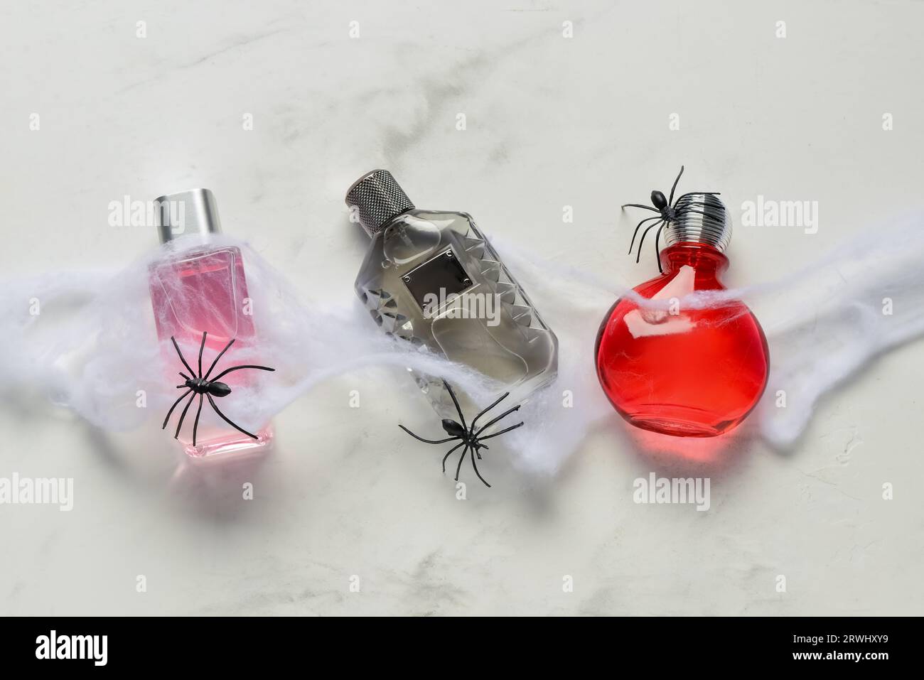 Bottles of elegant perfume with spiderweb for Halloween celebration on ...