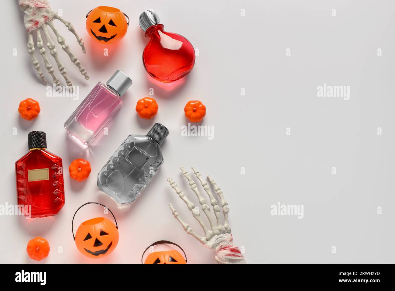 Bottles of elegant perfume with skeleton hands and pumpkins for ...
