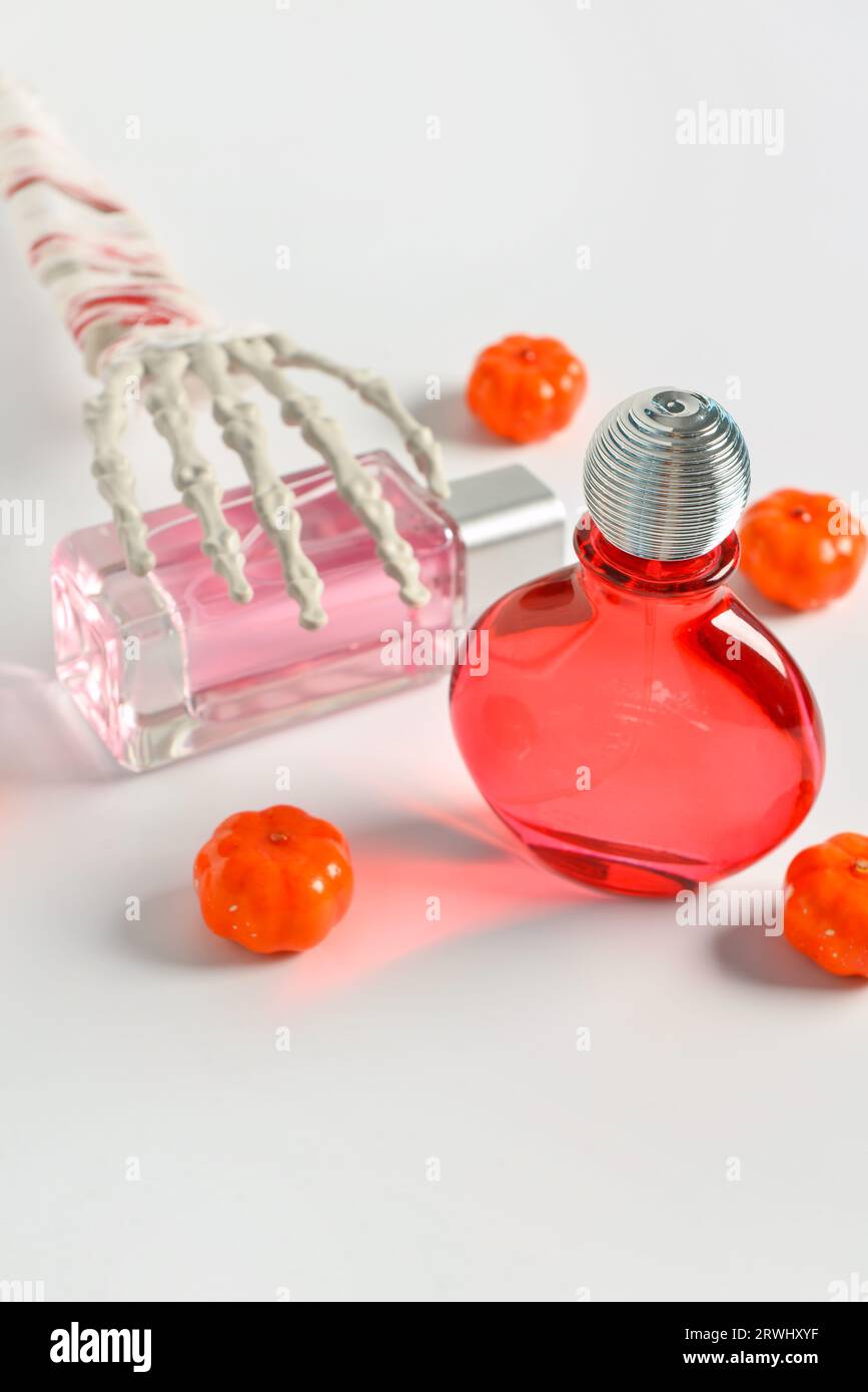 Bottles of elegant perfume with skeleton hand and pumpkins for ...