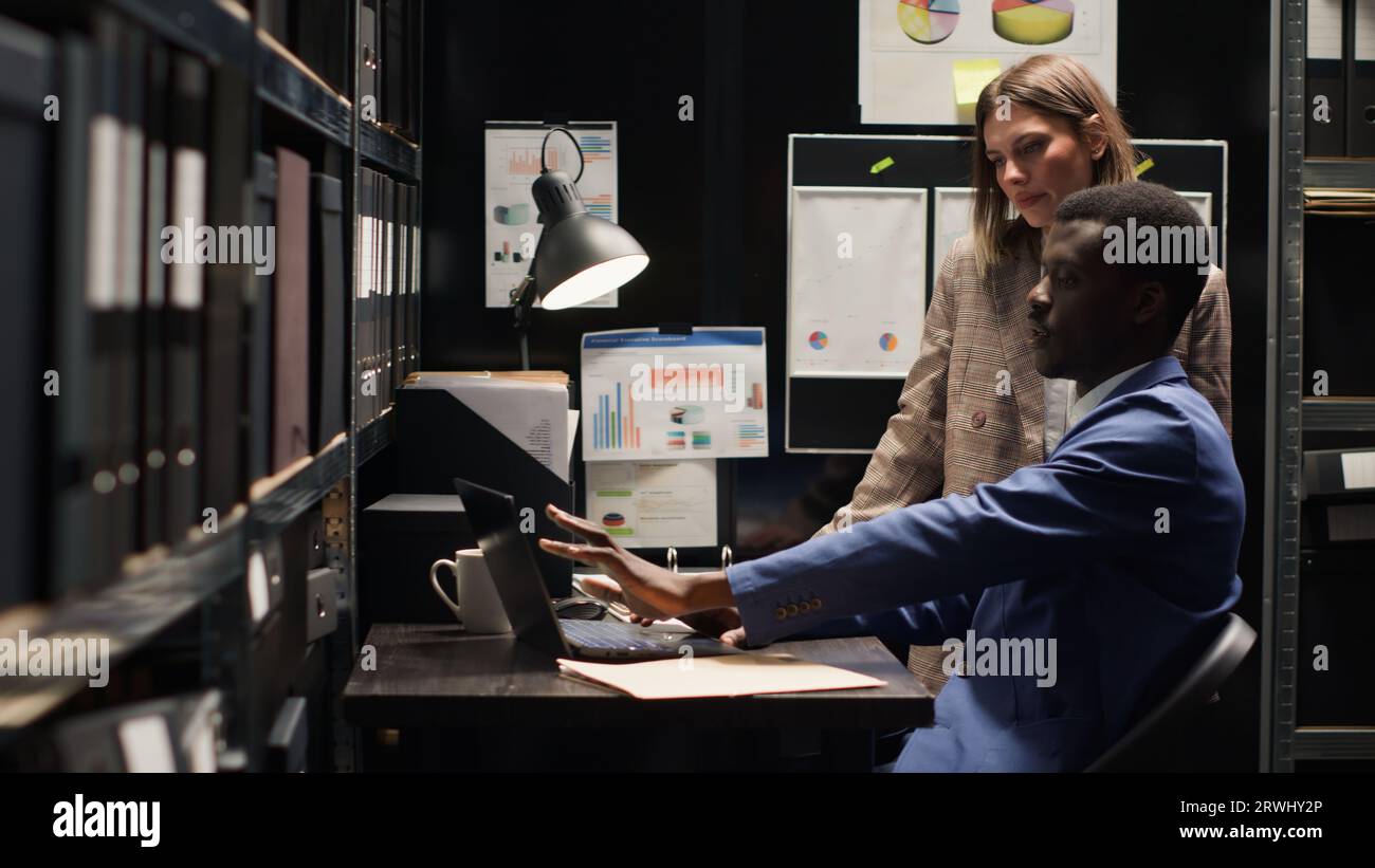 African american and caucasian police officers conduct detailed ...