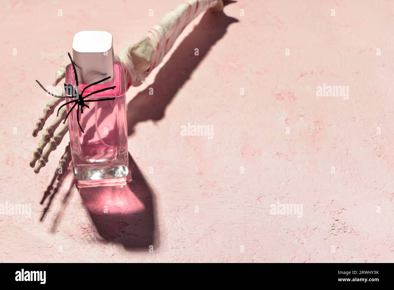 Bottle of elegant perfume with skeleton hand and spider for Halloween ...
