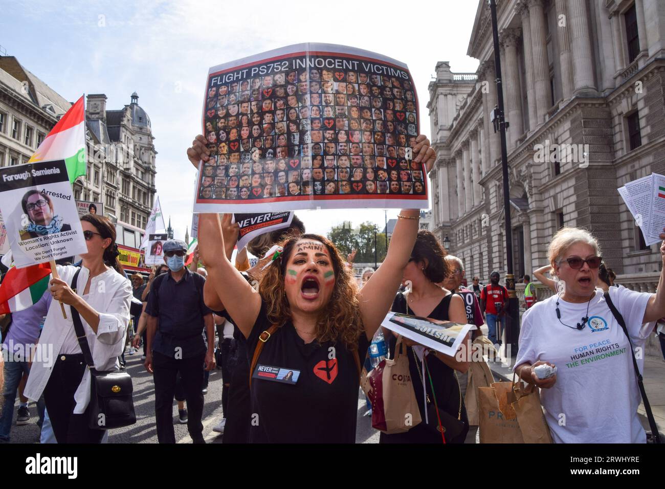 London, UK. 16th Sep, 2023. A protester hold a placard with pictures of ...