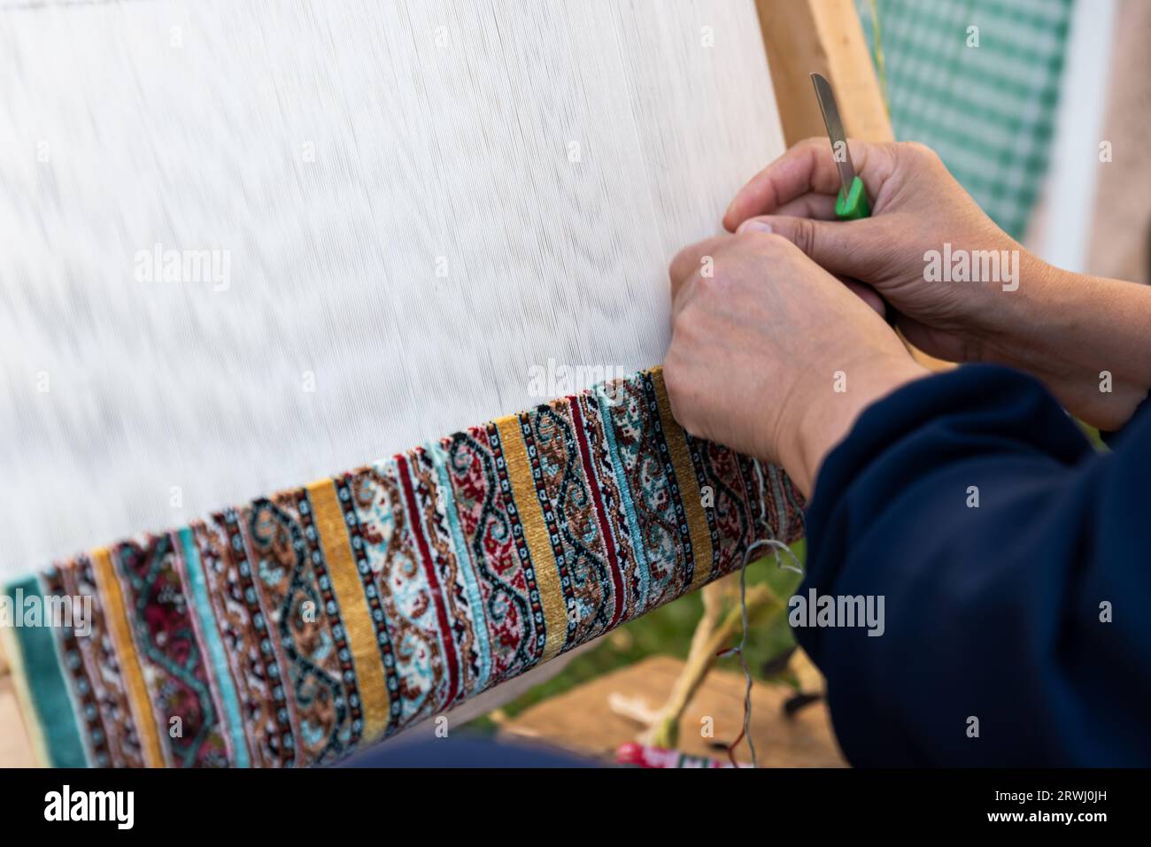 Carpet weaving using traditional techniques on a loom. , close-up of ...