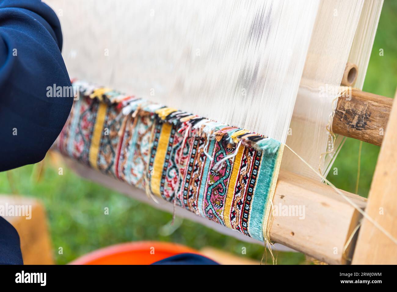 Carpet weaving using traditional techniques on a loom. , close-up of ...
