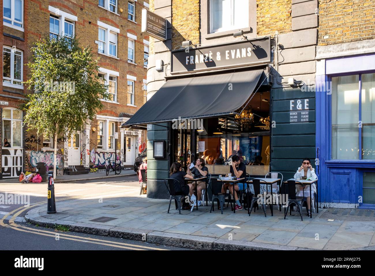 Young People Sitting Down Outside The Franze & Evans Cafe/Restaurant ...