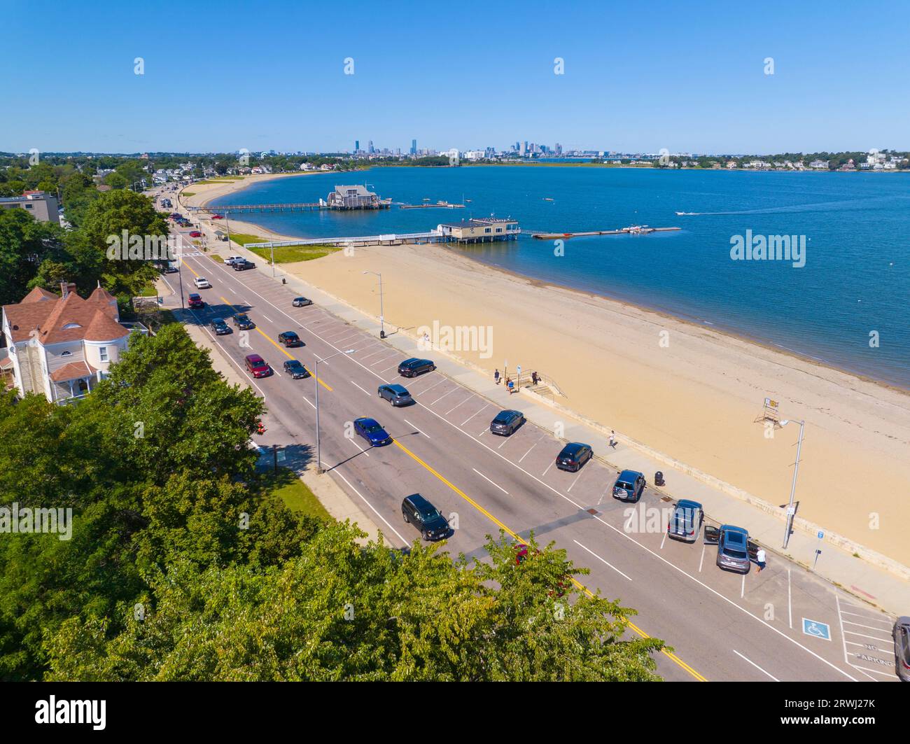 Wollaston Beach aerial view with Squantum and Wollaston Yacht Club with Boston city skyline in ...