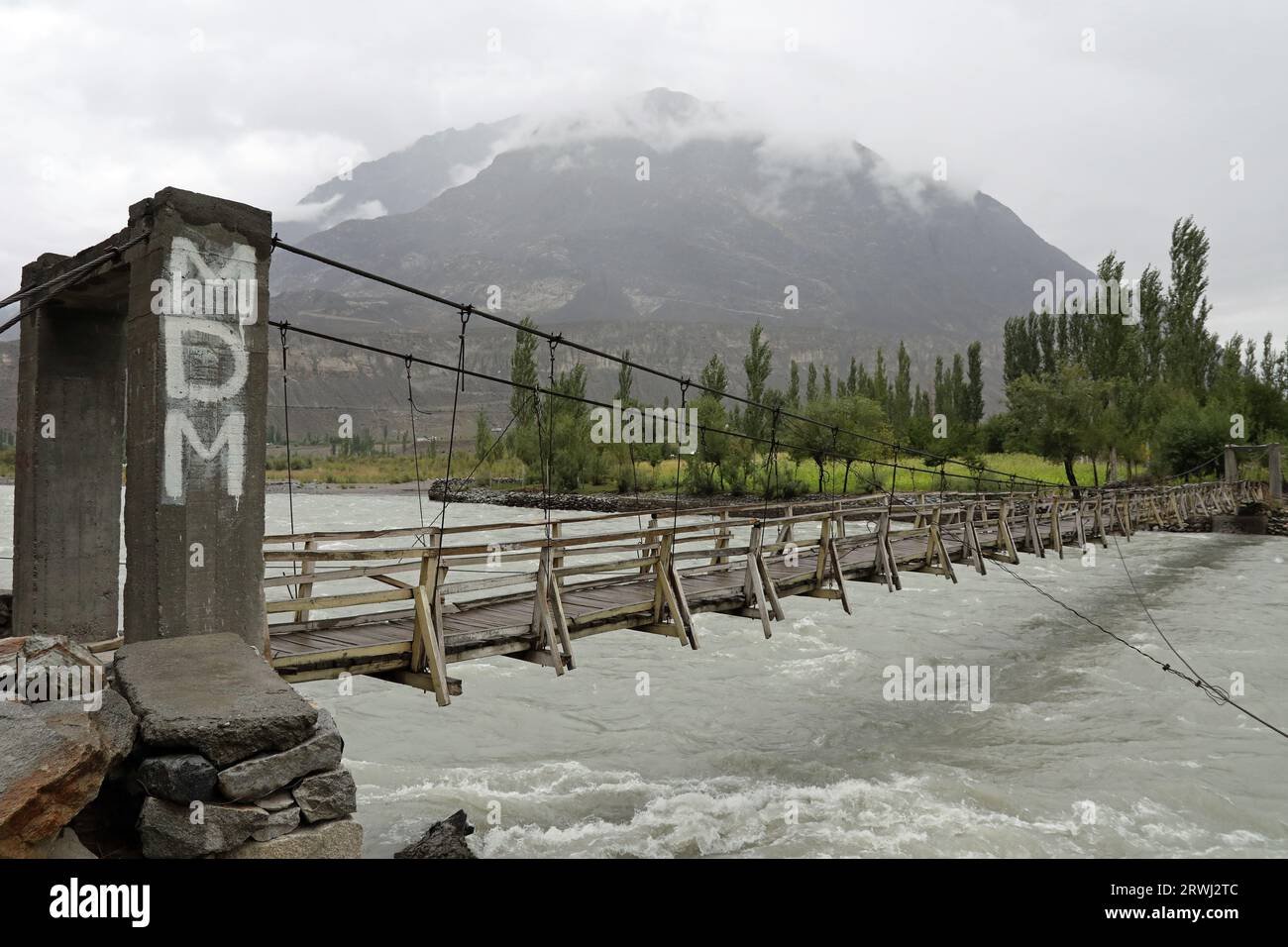 Rickety wooden footbridge in the Gilgit Baltistan region of northern ...