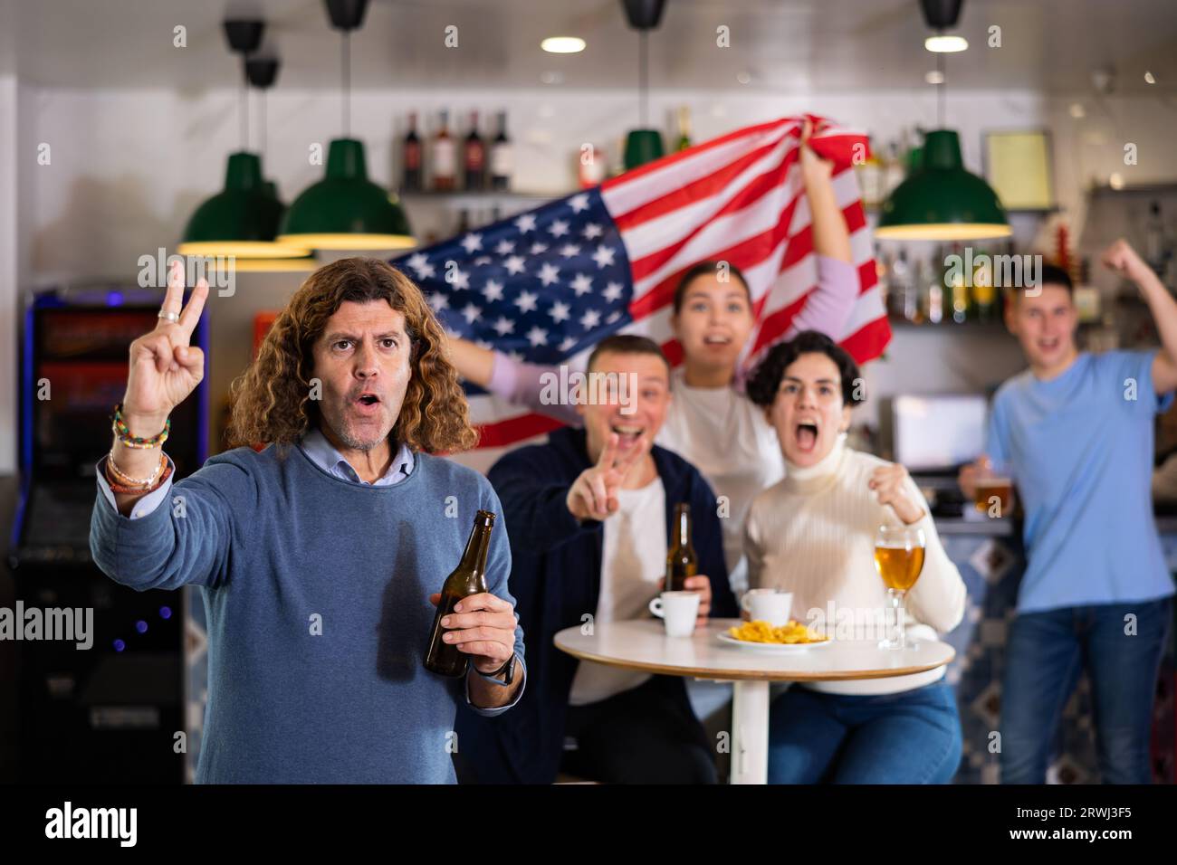 Group of friends supporters cheering for favorite team with flag of USA ...