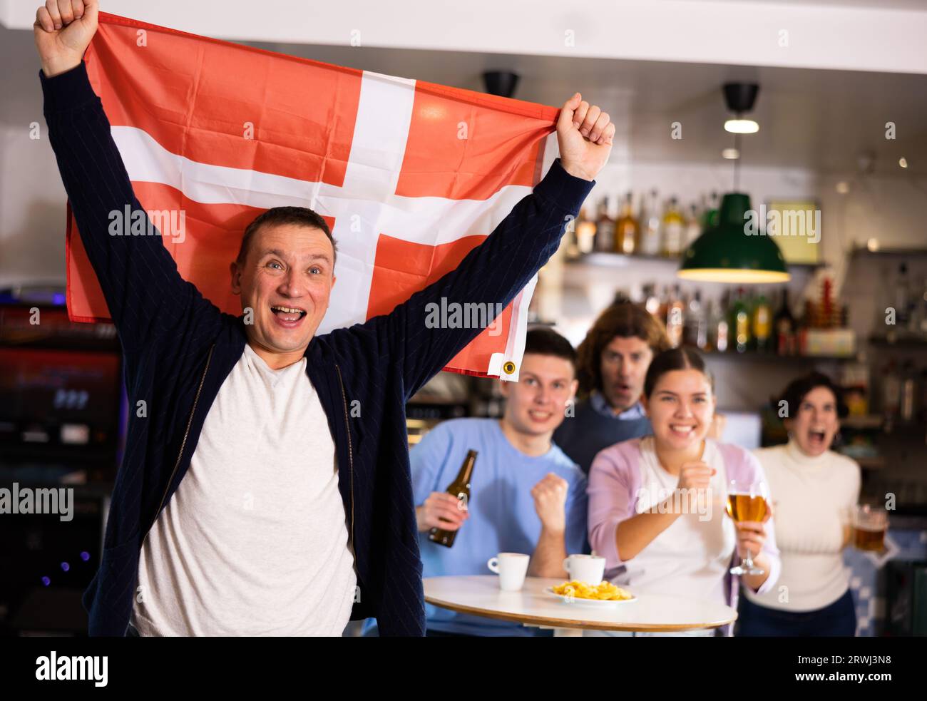 Danish fans scream with joy in beer bar. Denmark win Stock Photo - Alamy