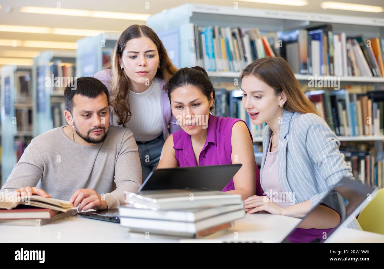 Group portrait of smiling positive engaged in research, working ...