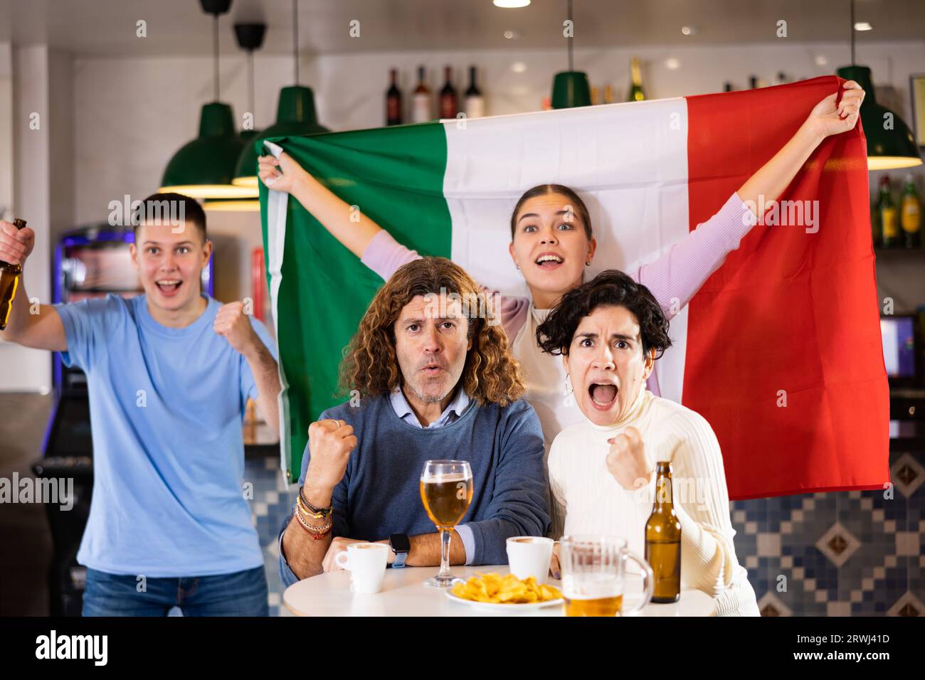 Joyful fans of the Italian team celebrating the victory in night bar ...
