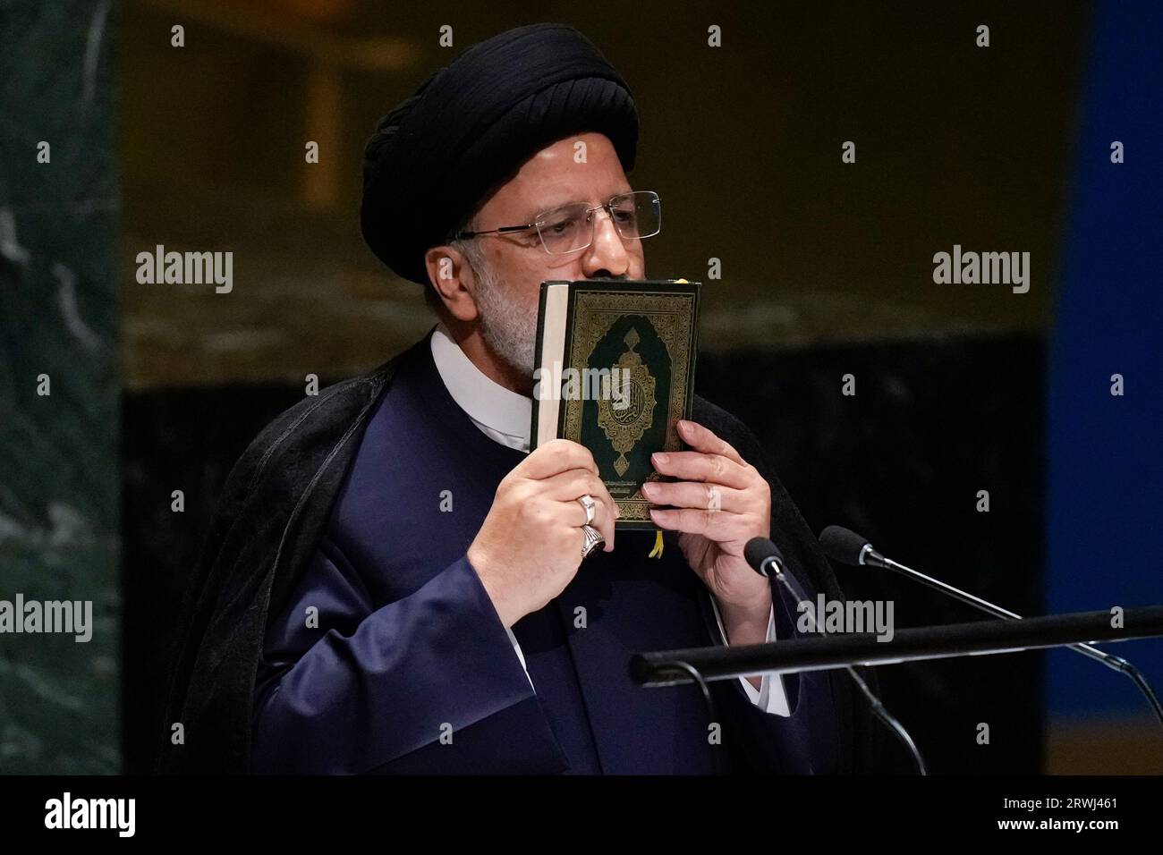 Iran’s President Ebrahim Raisi kisses a Quran as he addresses the 78th ...