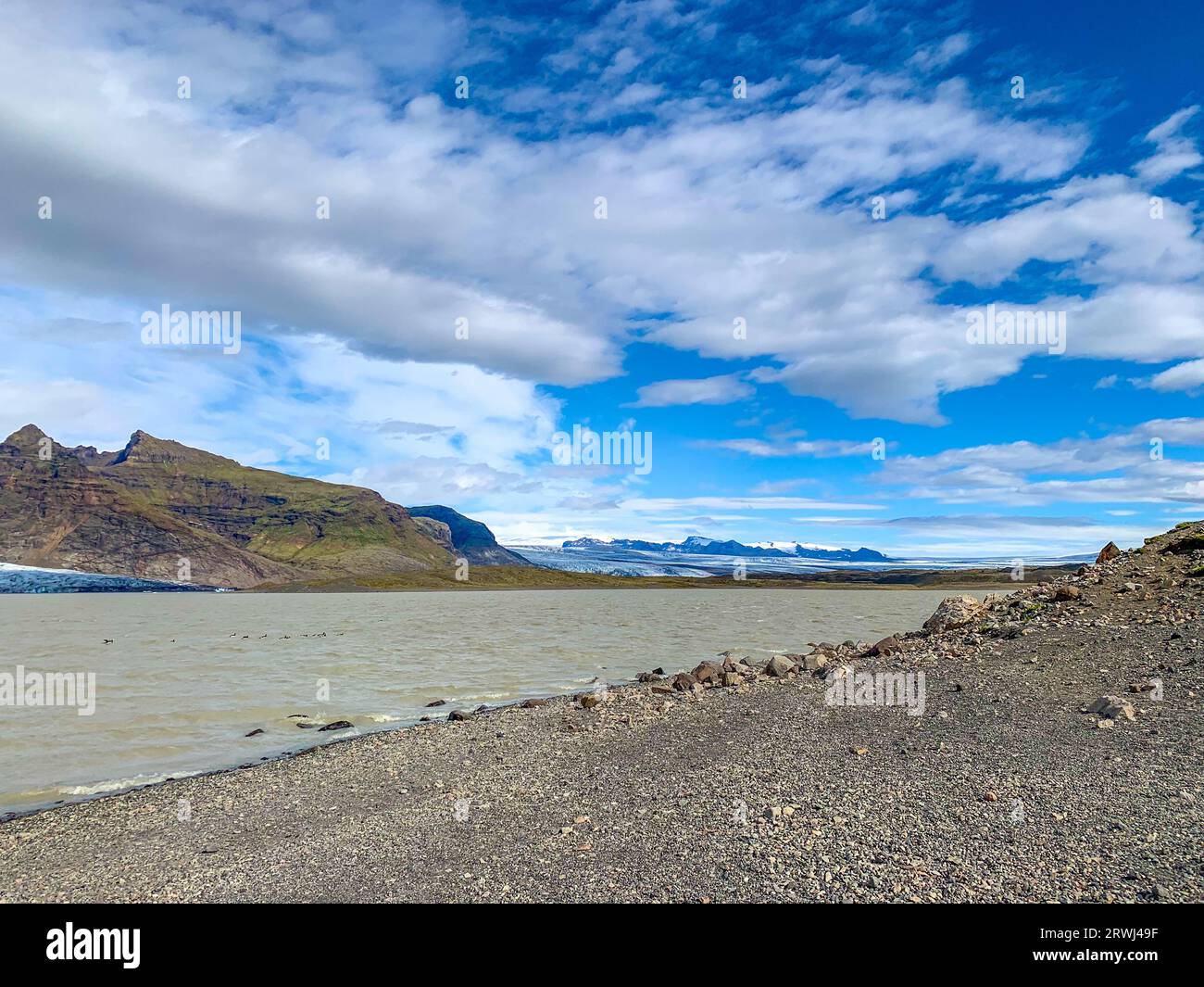 cloudy sky and small iceberg floating on the lake at scenic Fjallsarlon ...