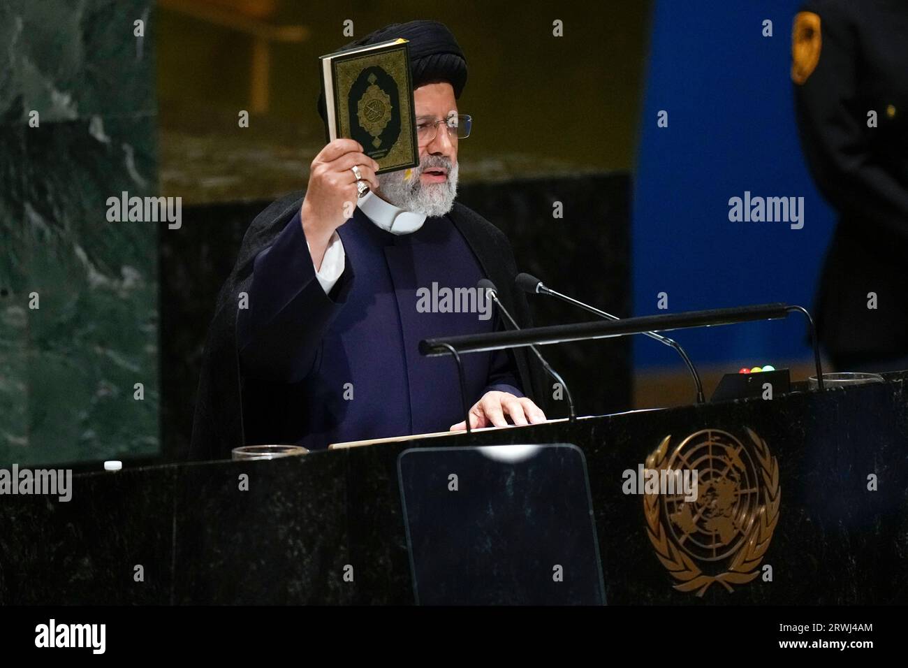 Iran’s President Ebrahim Raisi holds a Quran as he addresses the 78th ...