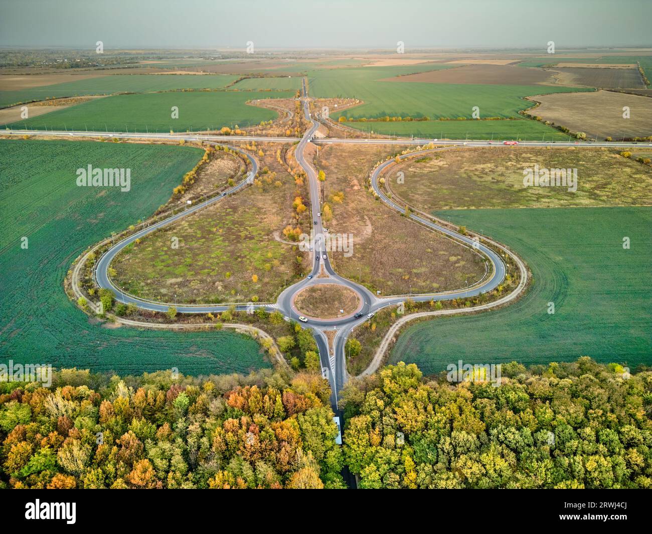 Aerial view on circular road intersection in beautiful autumn forest ...