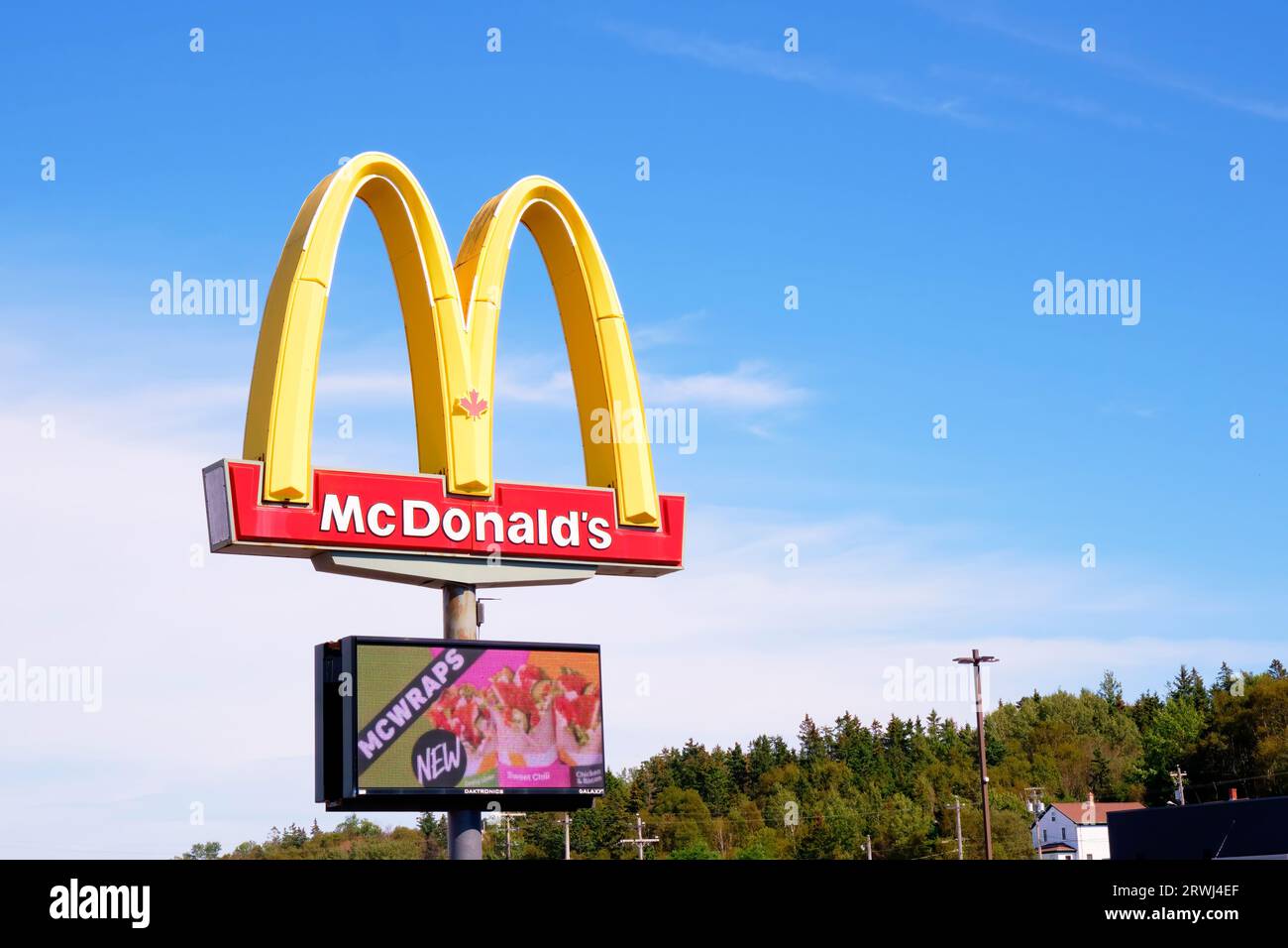 McDonald's sign framed against a blue sky photographed in landscape ...