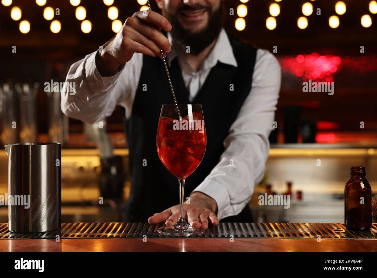 Bartender making fresh alcoholic cocktail at bar counter, closeup Stock ...