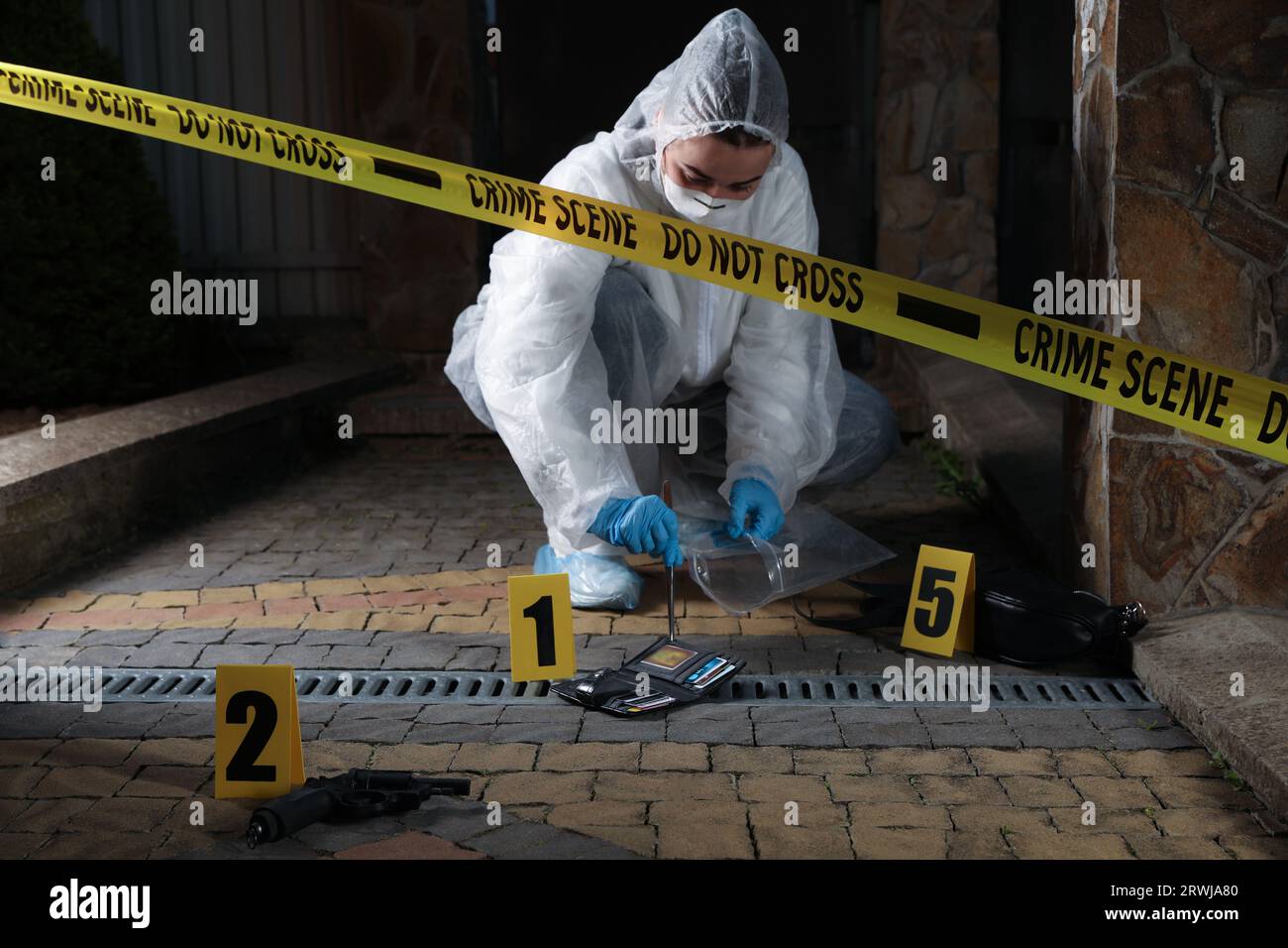 Criminologist working with evidences at crime scene outdoors Stock ...