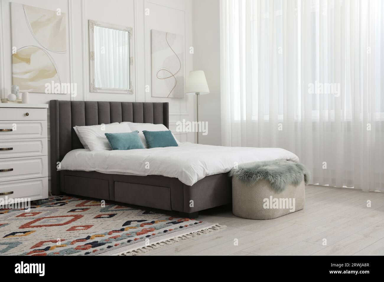 Large comfortable bed with cushions in bedroom. Interior design Stock ...