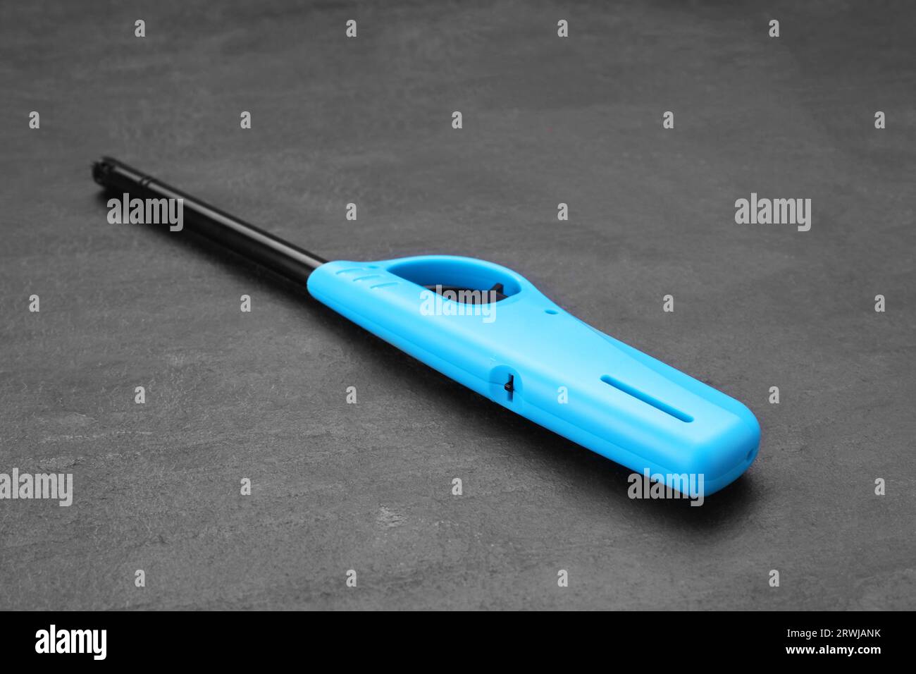 One gas lighter on black textured background Stock Photo - Alamy