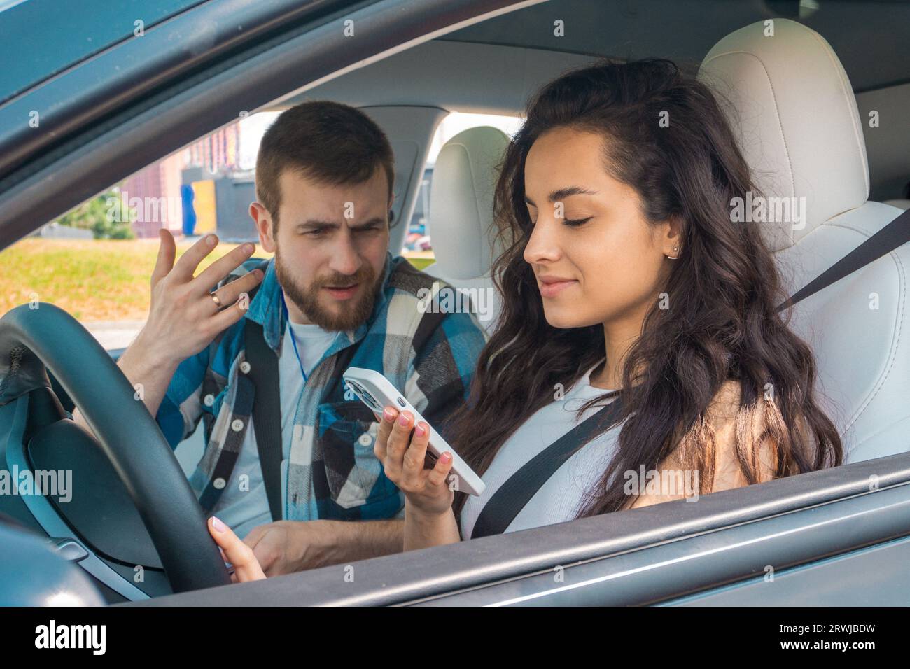Smiling pretty woman typing on the smartphone while sitting on the ...