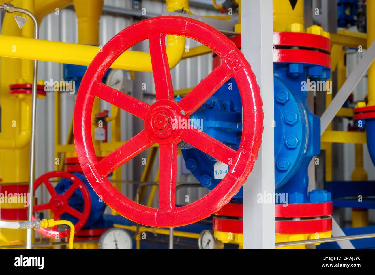 Red shut-off valve of gas tap close-up. Gas distribution station ...