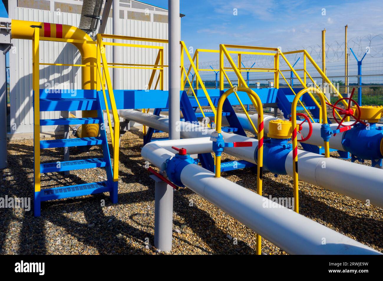 View of equipment and pipes of gas distribution station on summer day ...