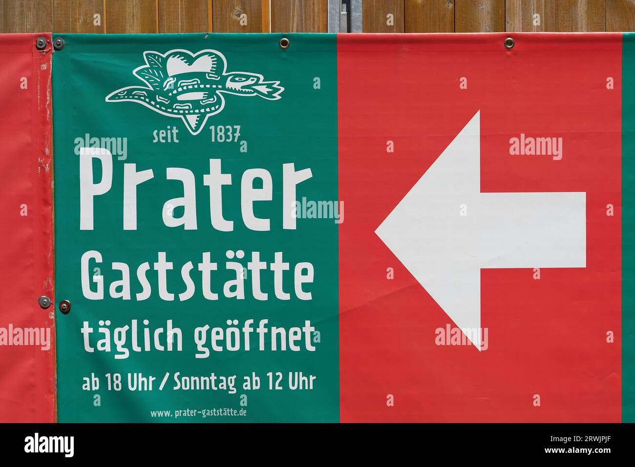 Advertisement with directional arrow on a fence for the oldest beer ...