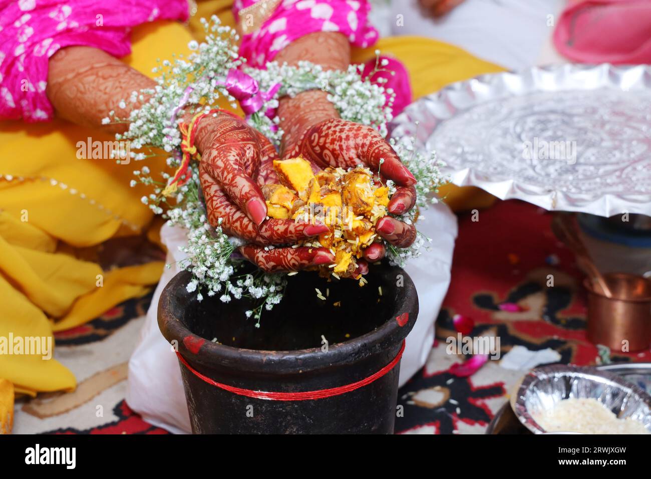 Closeup of hands doing pooja for haladi ritual before marriage Stock ...