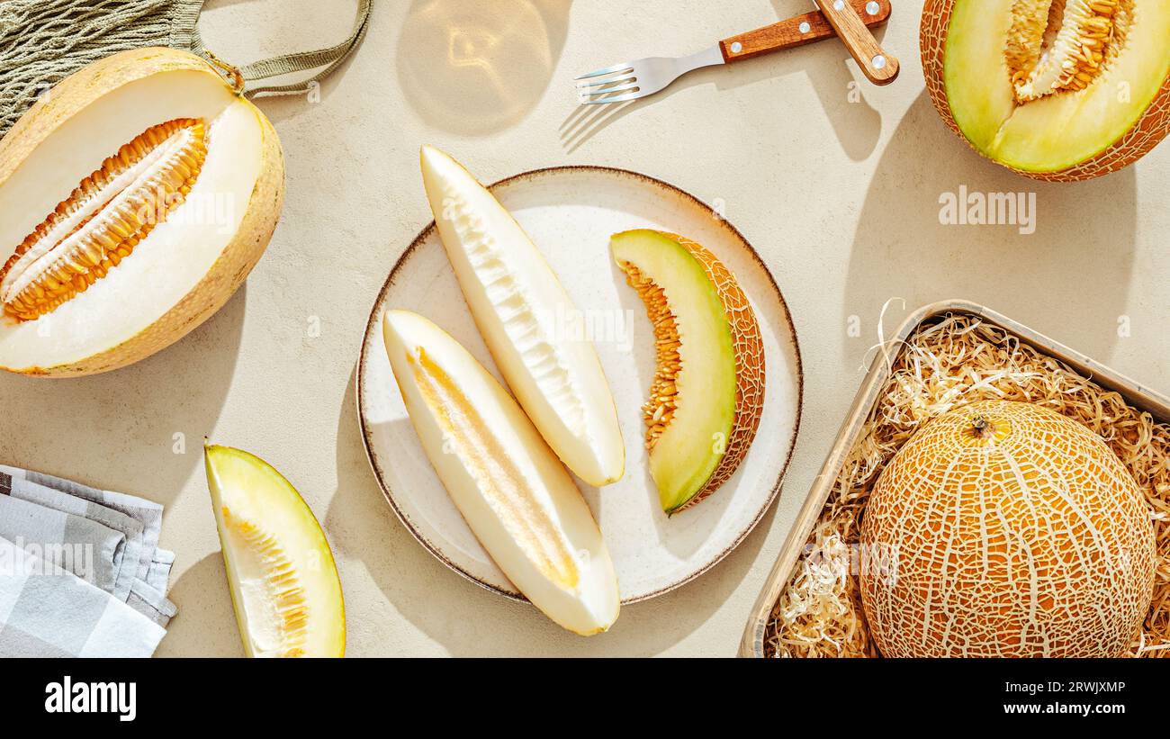 Various sliced melons on a light stone background Stock Photo - Alamy