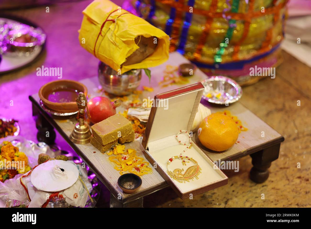 Gold nath and sweets on pooja at indian wedding event Stock Photo - Alamy