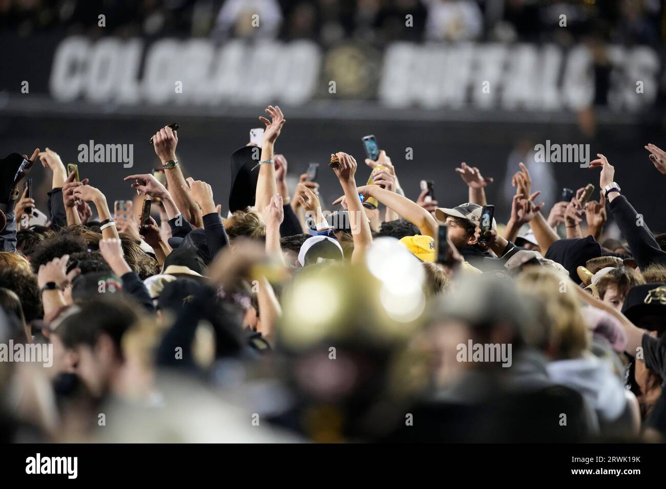 Colorado fans storm the field after an overtime victory over Colorado ...
