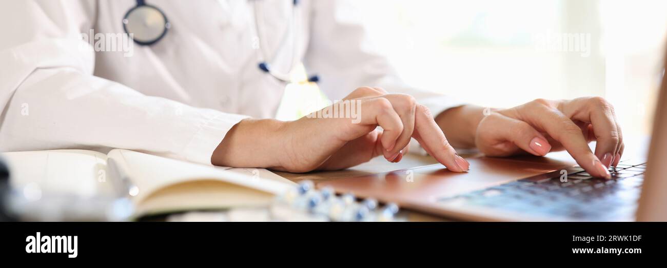 busy doctor with laptop computer Stock Photo - Alamy