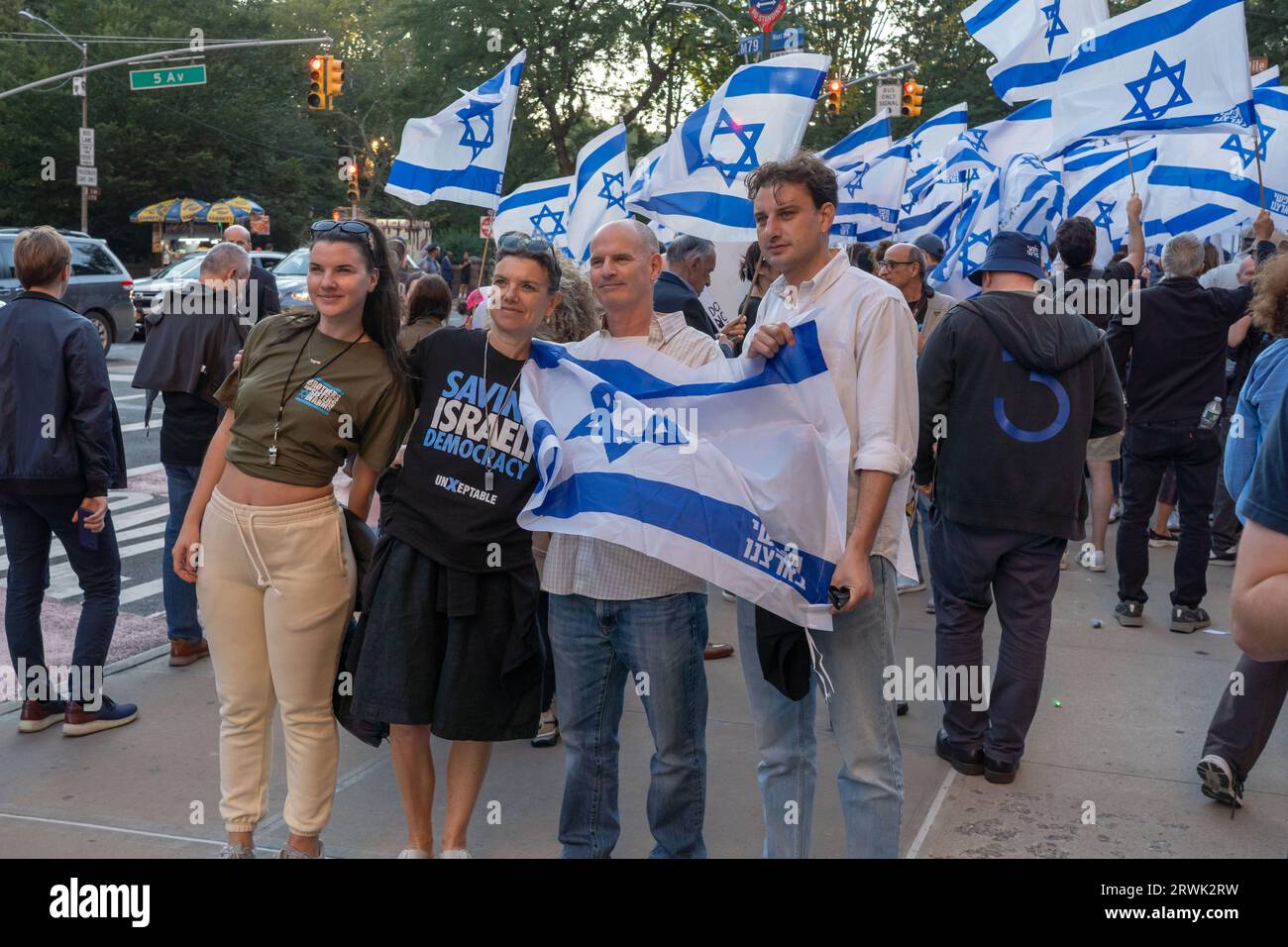 NEW YORK, NEW YORK - SEPTEMBER 19: Protesters pose with an Israeli flag ...