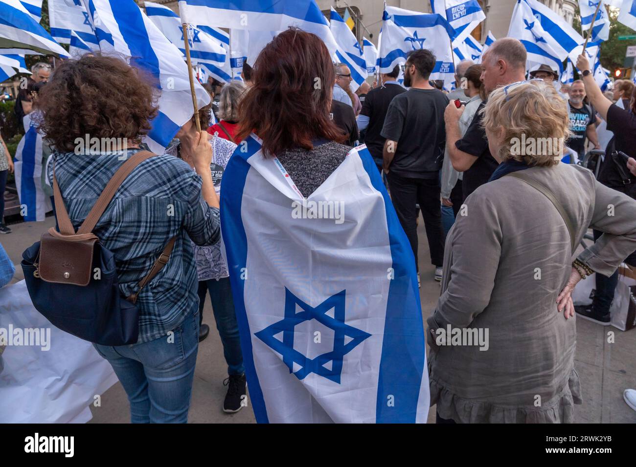 NEW YORK, NEW YORK - SEPTEMBER 19: Protester draped in Israeli flag ...