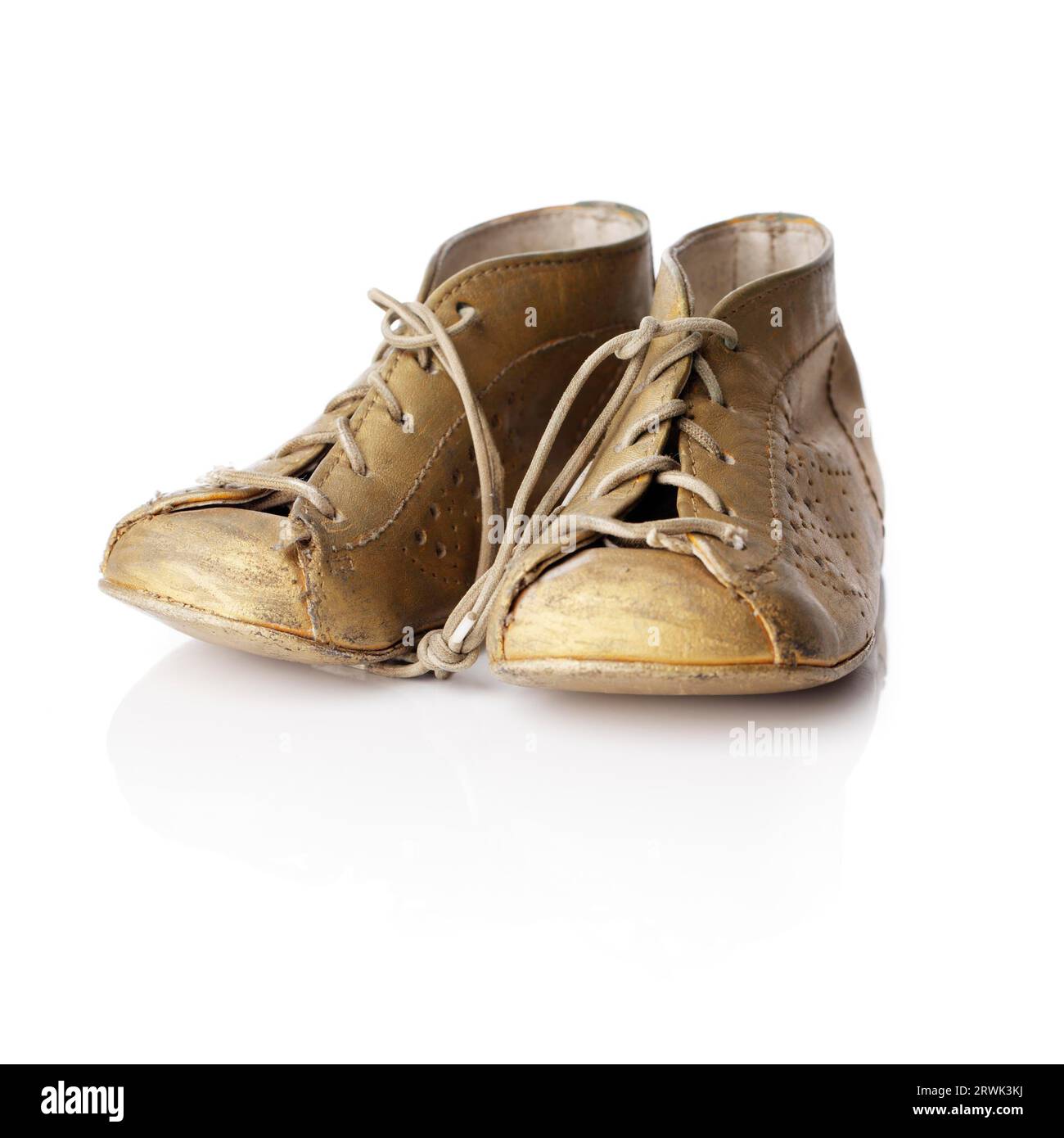 A Pair of old baby shoes on white reflecting background Stock Photo - Alamy