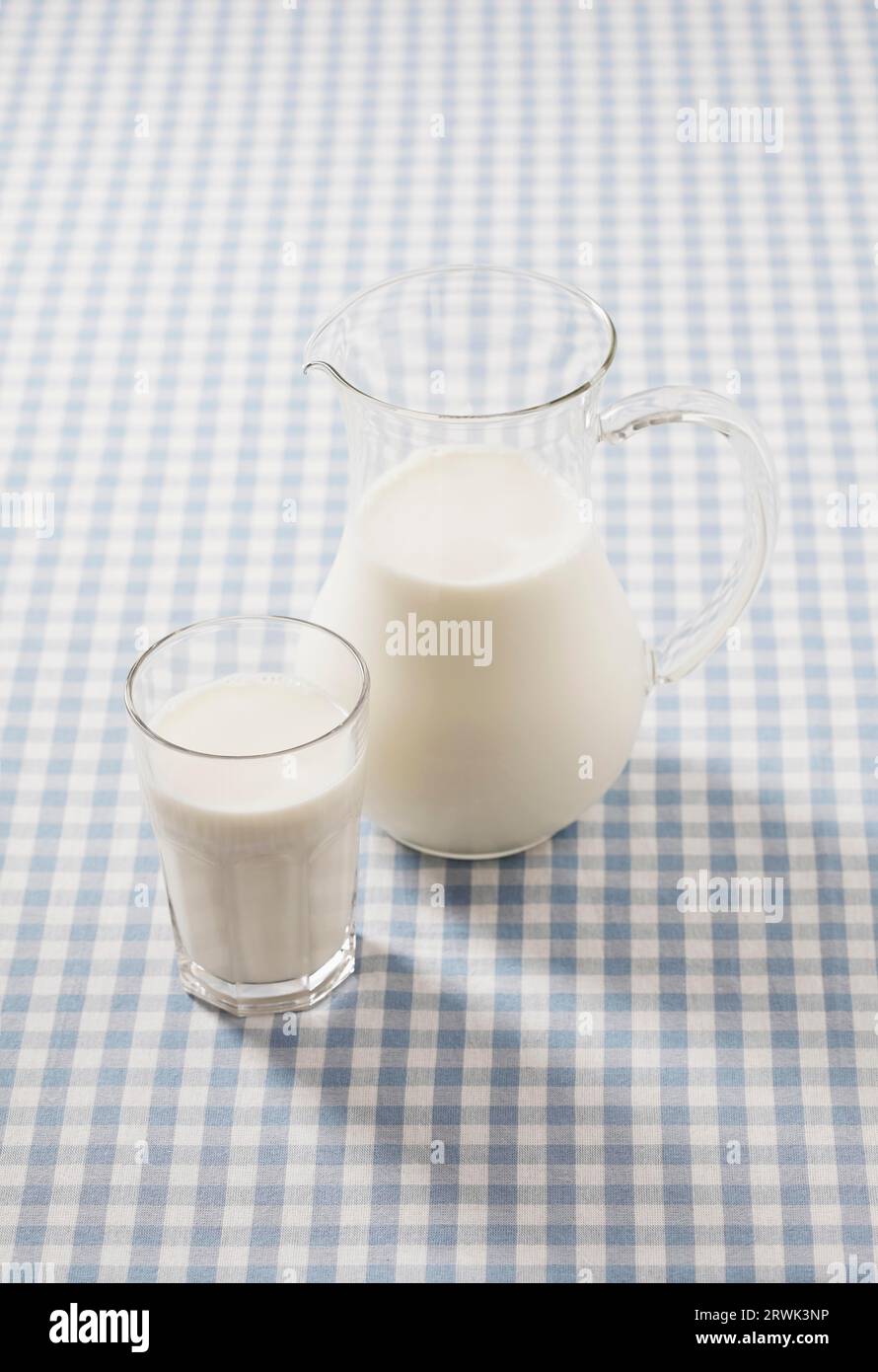 A Glass and a pitcher filled with milk Stock Photo - Alamy