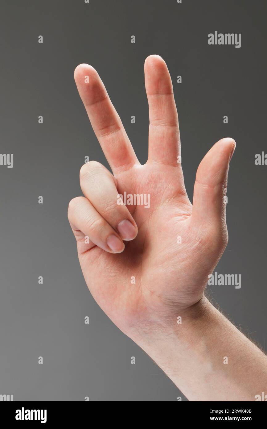 Hand of a man with three fingers pointing Stock Photo - Alamy