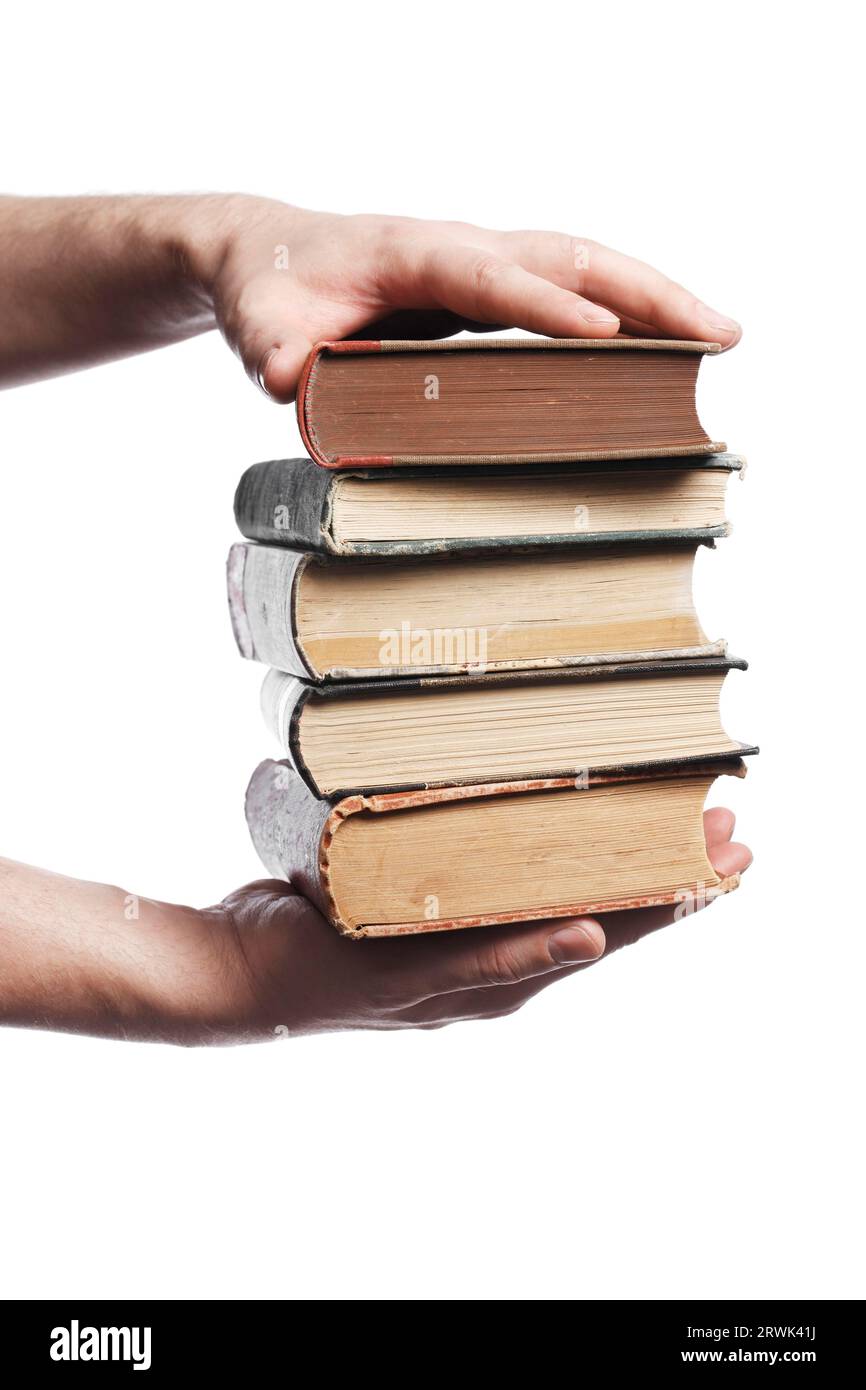 Man carrying a stack of book in his hands Stock Photo - Alamy
