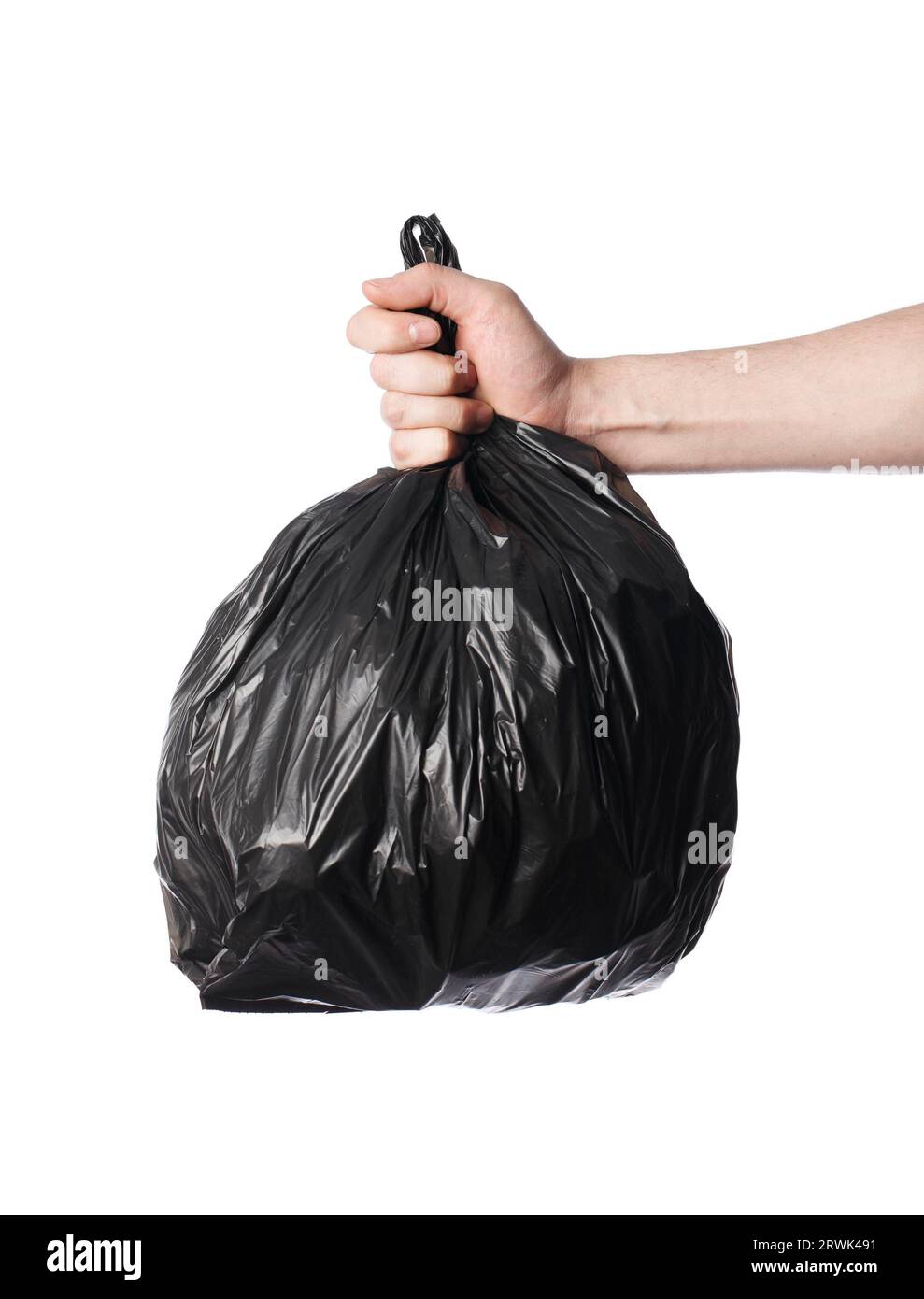 Man holding a full black plastic trash bag in his hand Stock Photo - Alamy