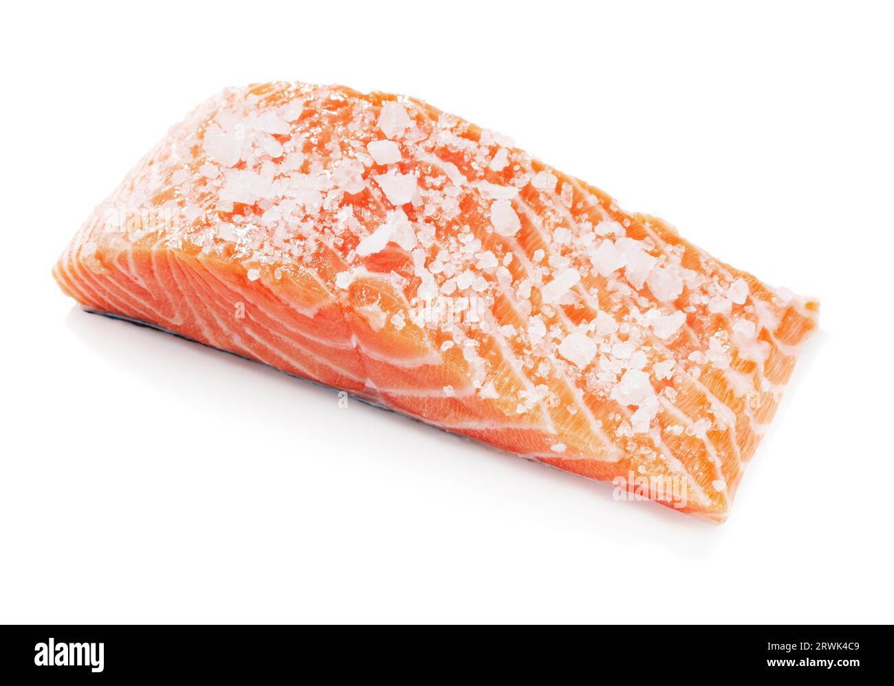 Salmon fish fillet salted with coarse salt. Isolated on white with ...