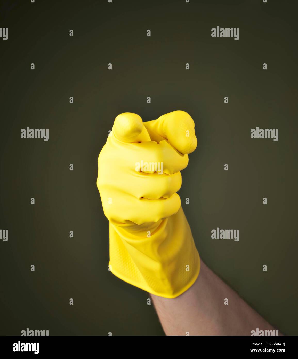 Hand with yellow protective rubber glove pointing with finger Stock ...