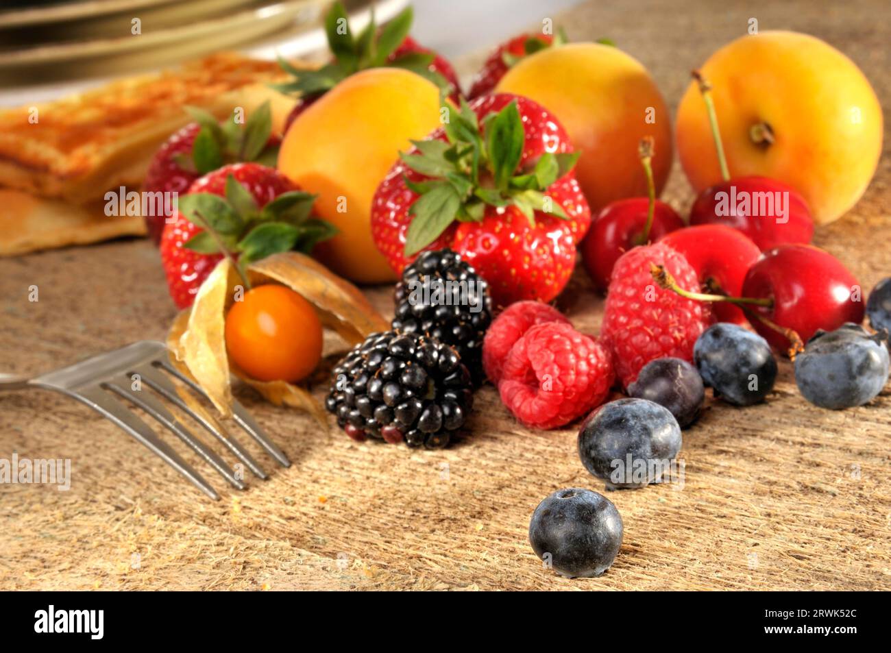 Fruits on wood with wafer and fork Stock Photo - Alamy