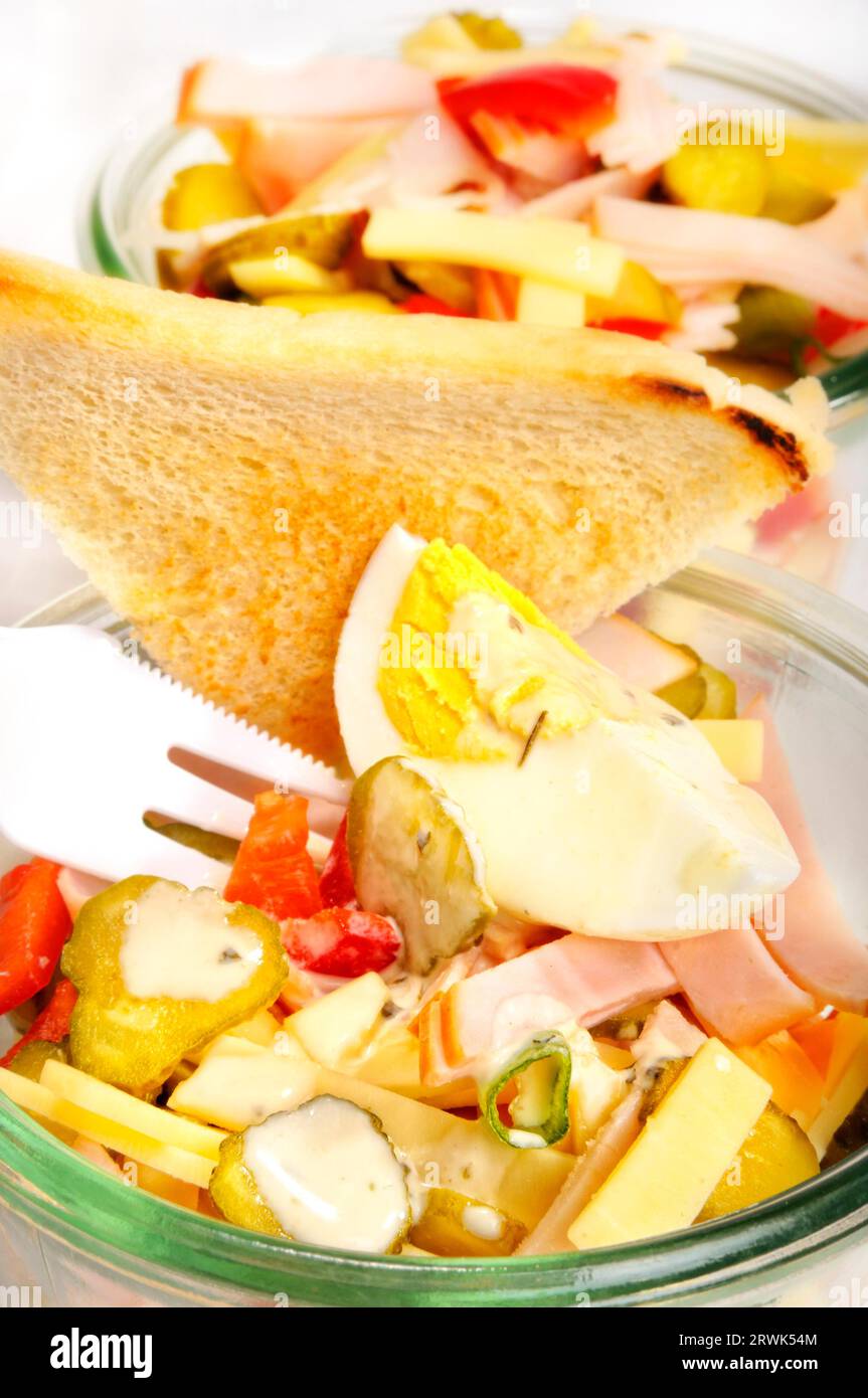Sausage salad with egg and toast Stock Photo - Alamy