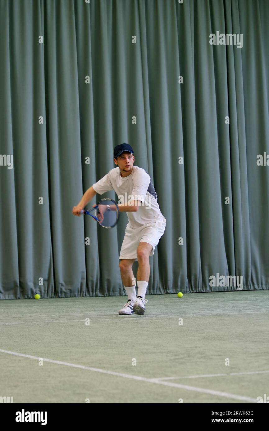 Tennis player in the recovery phase for the forehand stroke, indoor ...