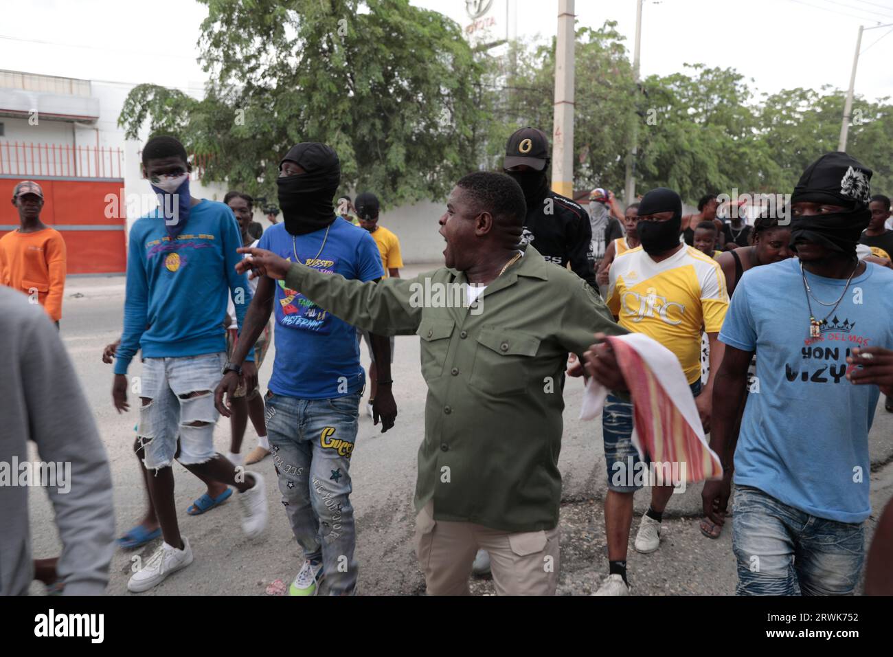 The leader of the "G9 and Family" group, Jimmy Chérizier, center ...