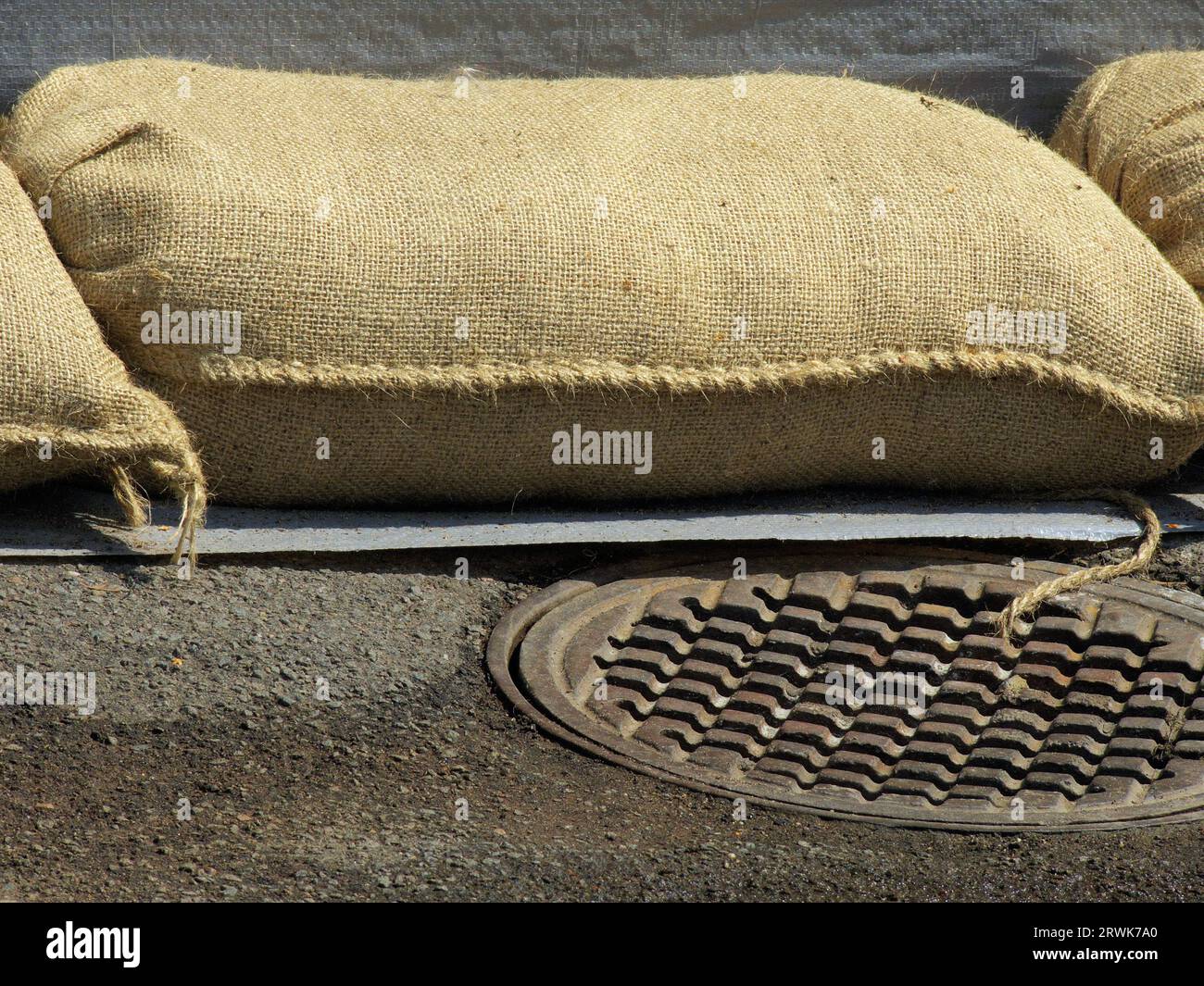 Sandbags in front of a manhole cover, as flood protection, detail Stock ...