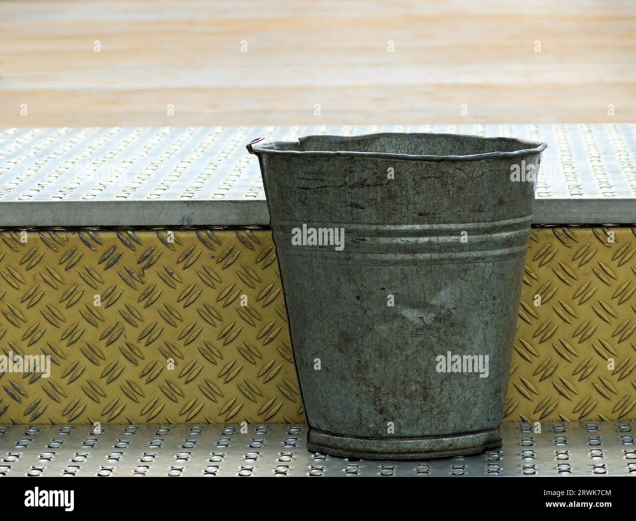 Zinc bucket in front of gold-coloured checker plate, cut-out Stock ...