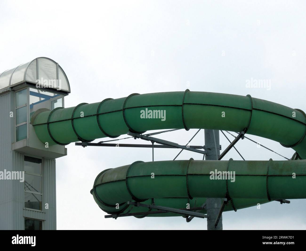 Green spiral water slide of an indoor swimming pool, detail, background ...
